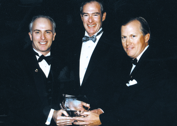 Robert J. McCann (left) and Christopher Quick (right) present the award ...